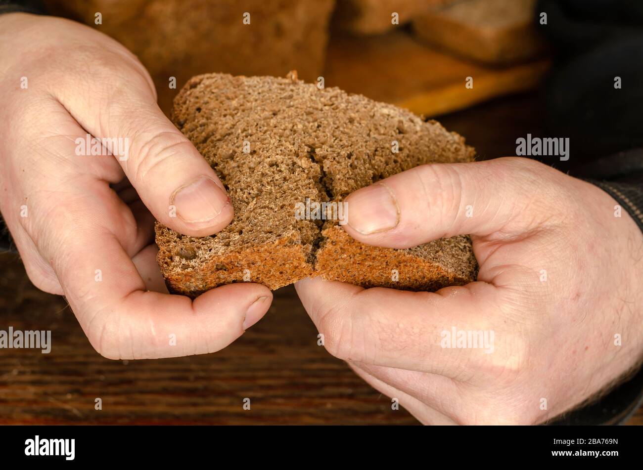 Hands breaking bread loaf share hi-res stock photography and images - Alamy
