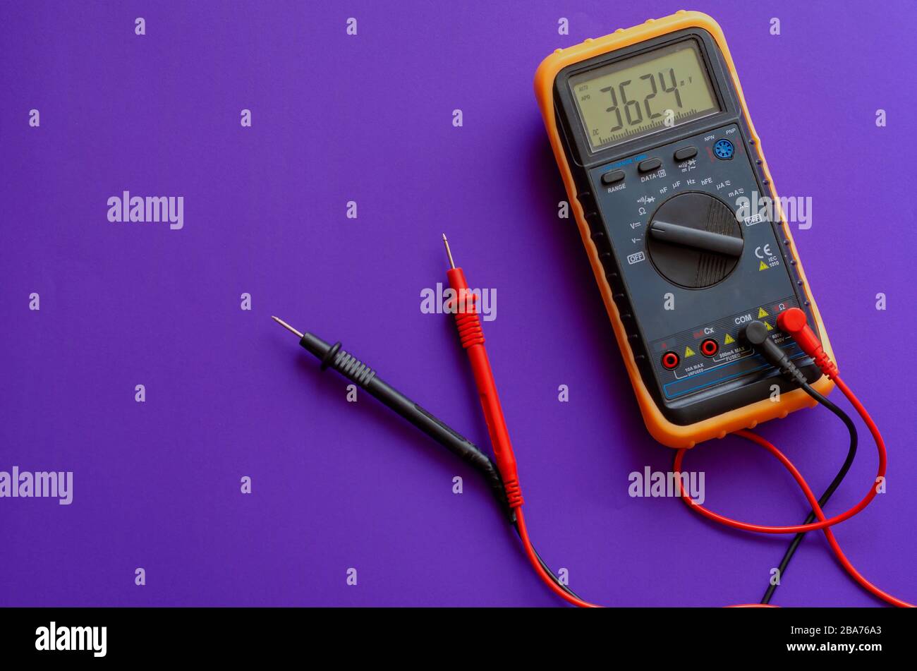 Multimeter on a lilac background. Yellow Multimeter, A multimeter or a ...