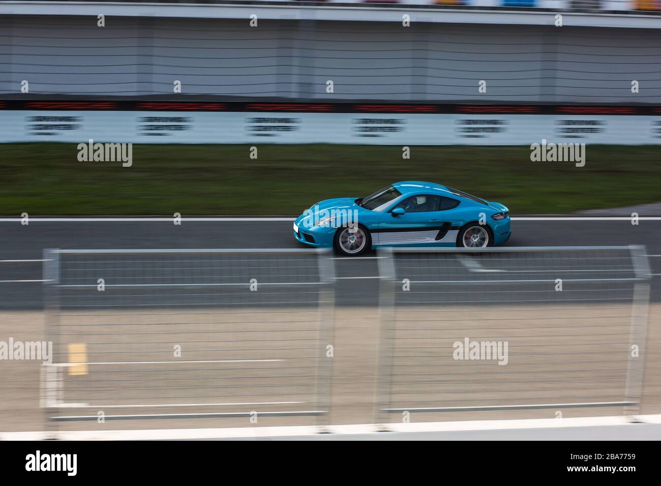 Blue racing sport car on the trace in the stadium. Fences around Stock ...