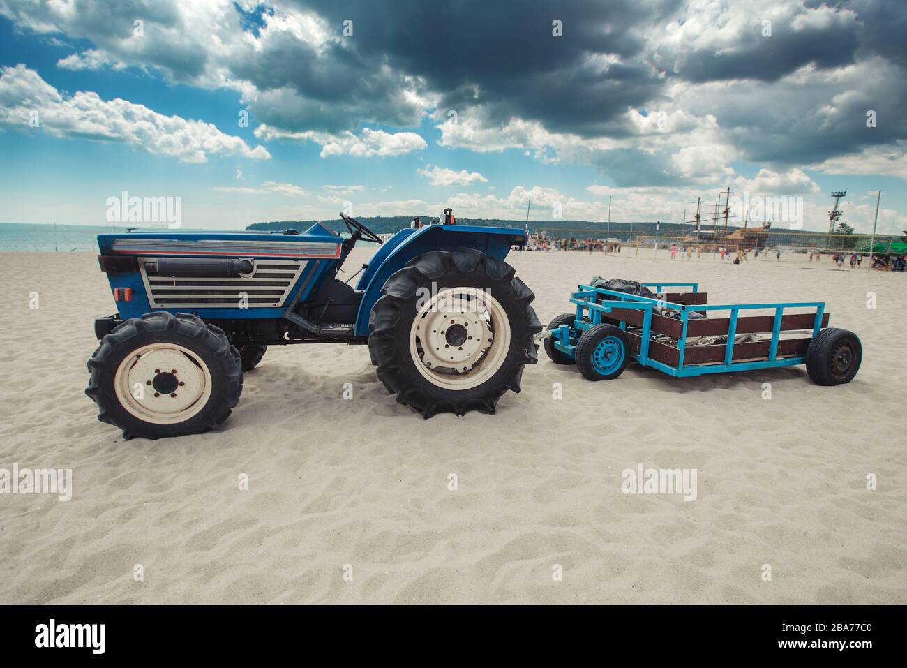 Tractor machine with trailer cleaning rubbish on the beach Stock Photo ...