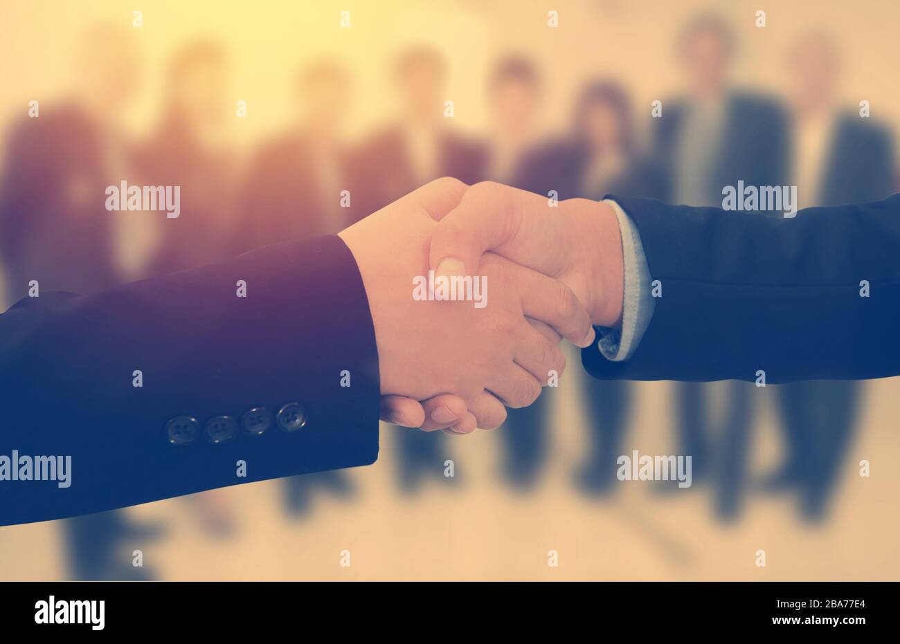 Business handshake in front of business people background Stock Photo ...