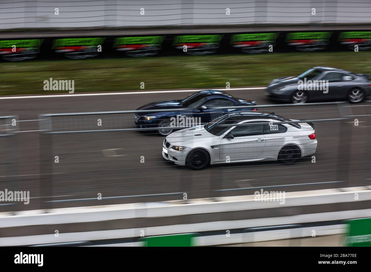 White and black sedans on the racing trace Stock Photo - Alamy