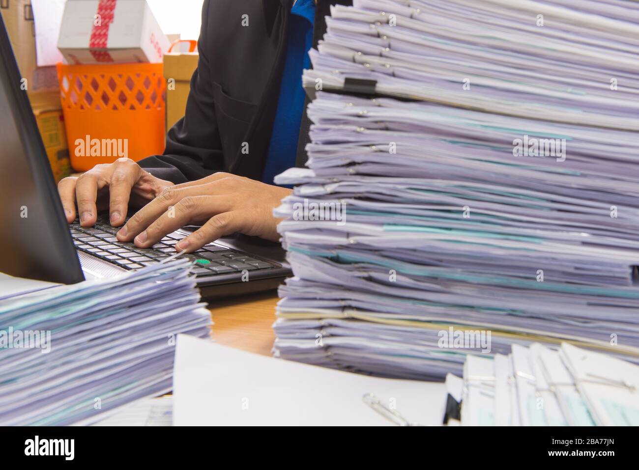 documents on desk stack up high waiting to be managed Stock Photo - Alamy
