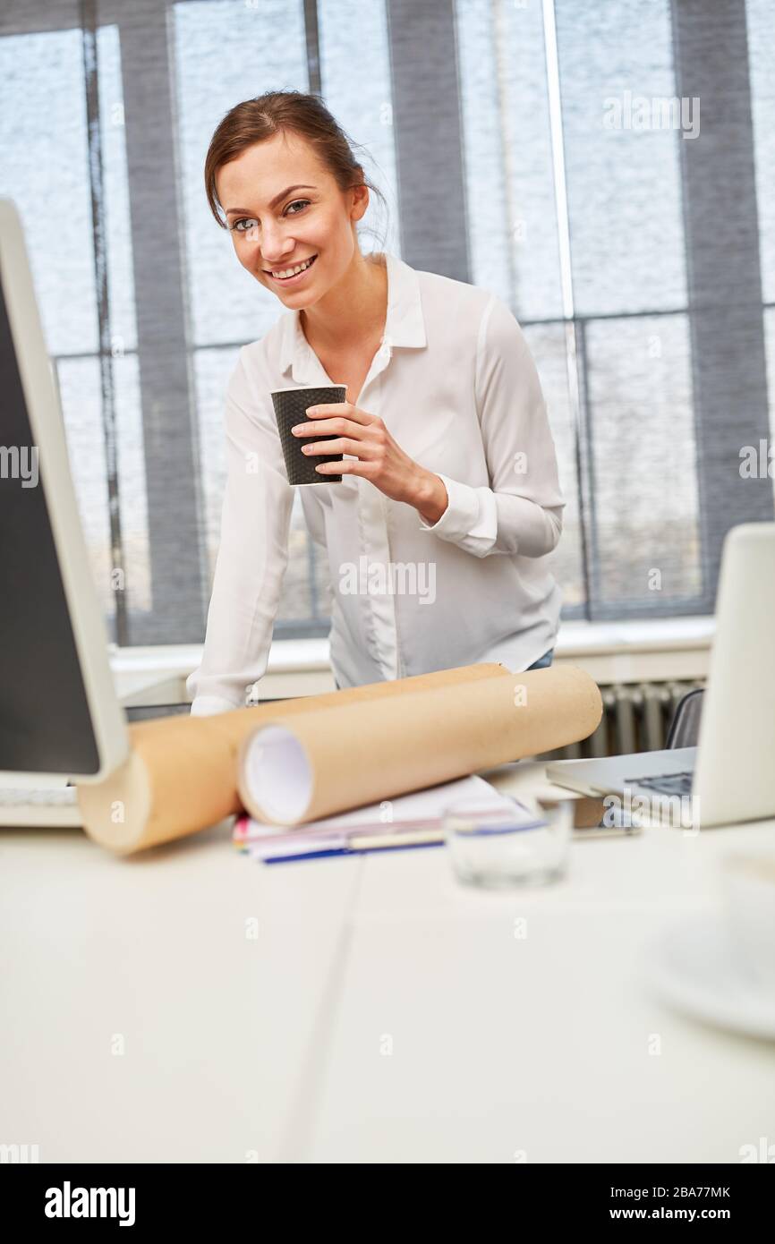 Young woman in office drinks coffee from plastic cup at work Stock ...