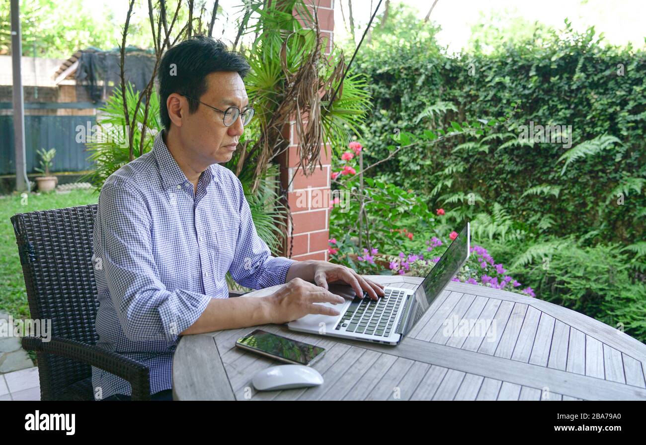 Work from home concept. Asian Chinese businessman working on the ...