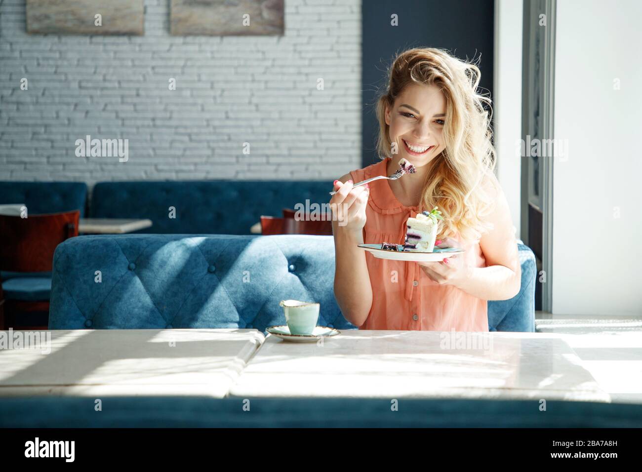 Girl has breakfast in a cafe Stock Photo - Alamy