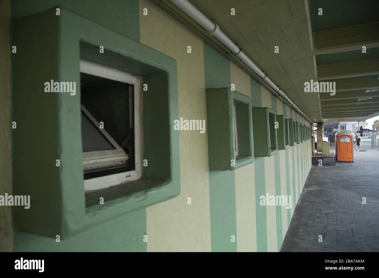 Green building with small windows in Israel Stock Photo - Alamy
