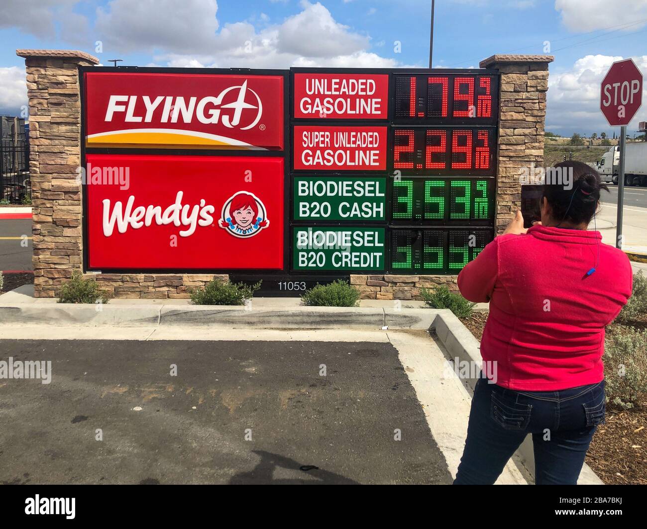 A person takes a photo of signage at a Flying J Travel Center gas ...
