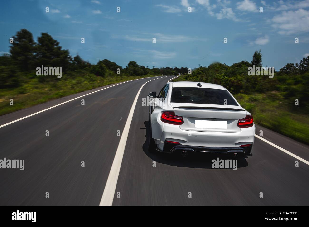 White vintage sport car on the road, back view Stock Photo - Alamy