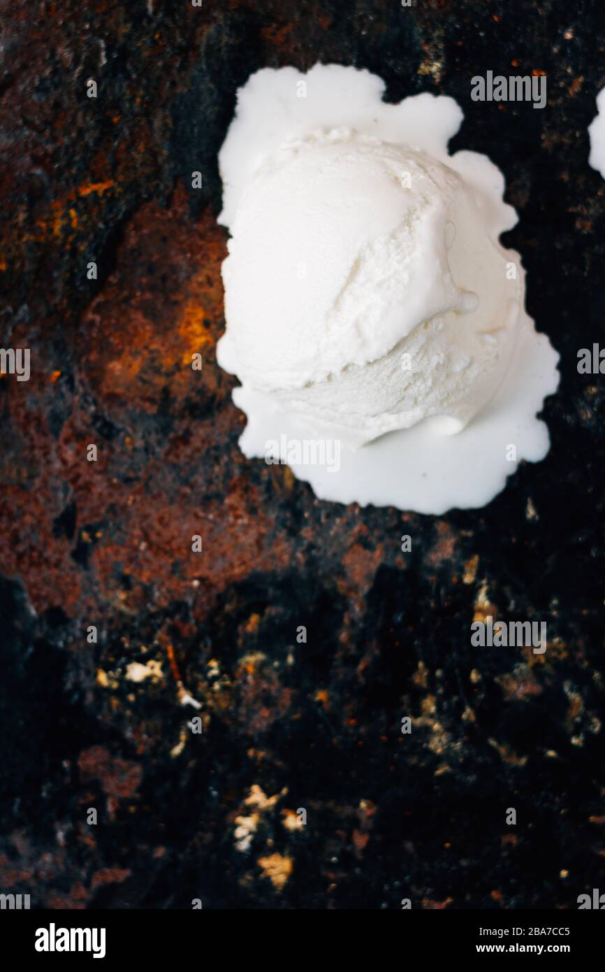Ball of melted ice cream on black rustic surface Stock Photo - Alamy