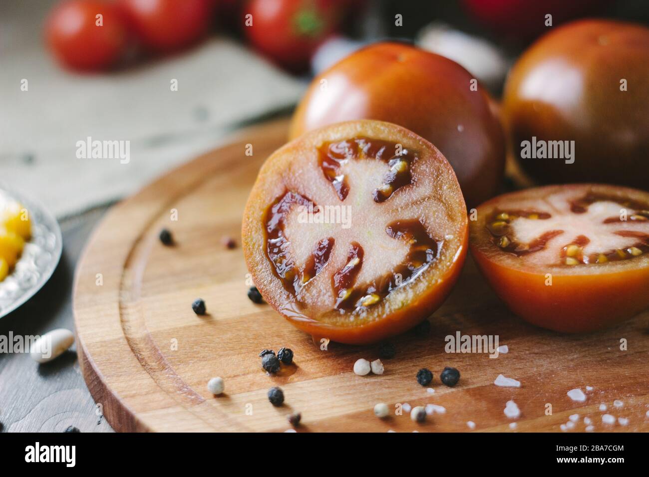 Kumato tomatoes on wooden hi-res stock photography and images - Alamy