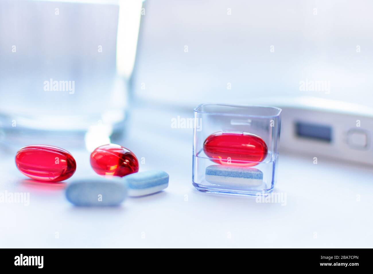 Red and blue capsules on white background. Pharmacy concept ...