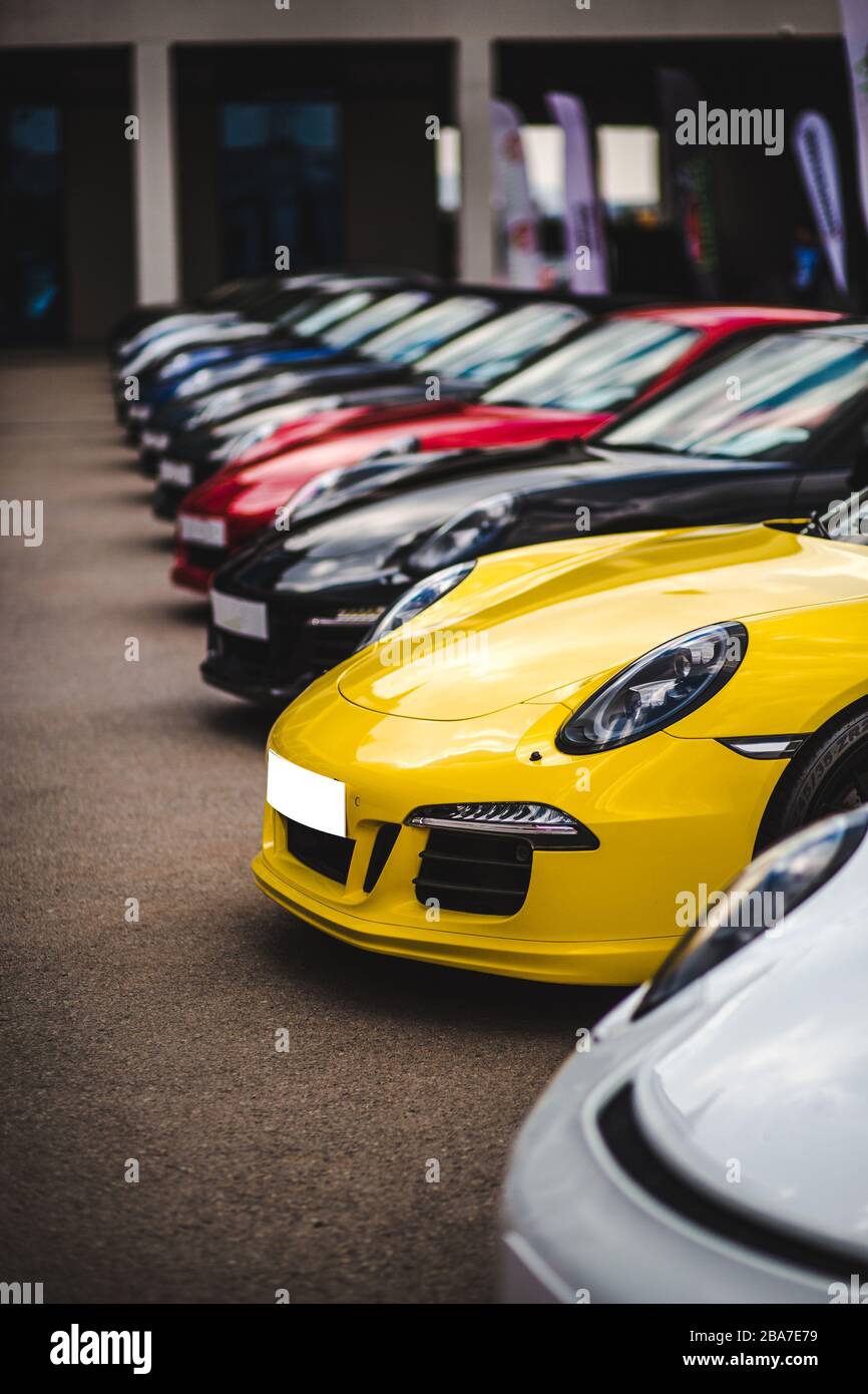 Colorful sport cars in a row in the showroom Stock Photo - Alamy