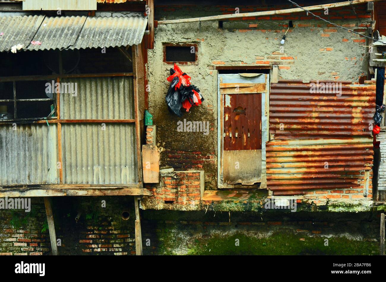 Slum house on the edge of a canal in Jakarta Stock Photo - Alamy