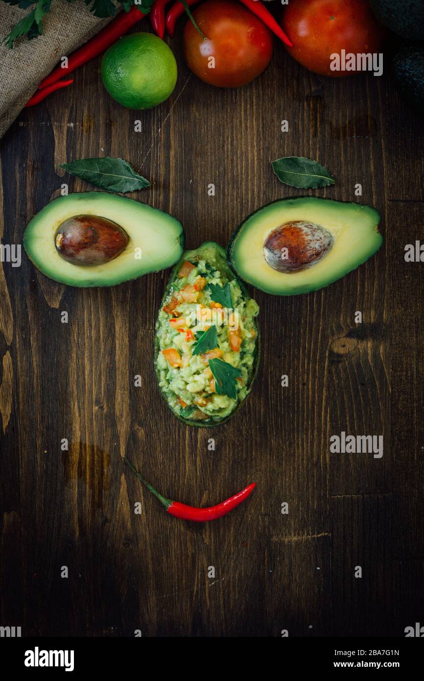 Funny food face made from avocado and guacamole dip Stock Photo - Alamy