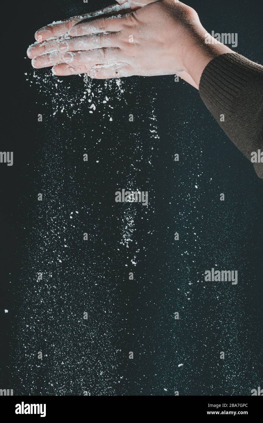 hand of woman cook in kitchen pouring white dust flour flour table for ...