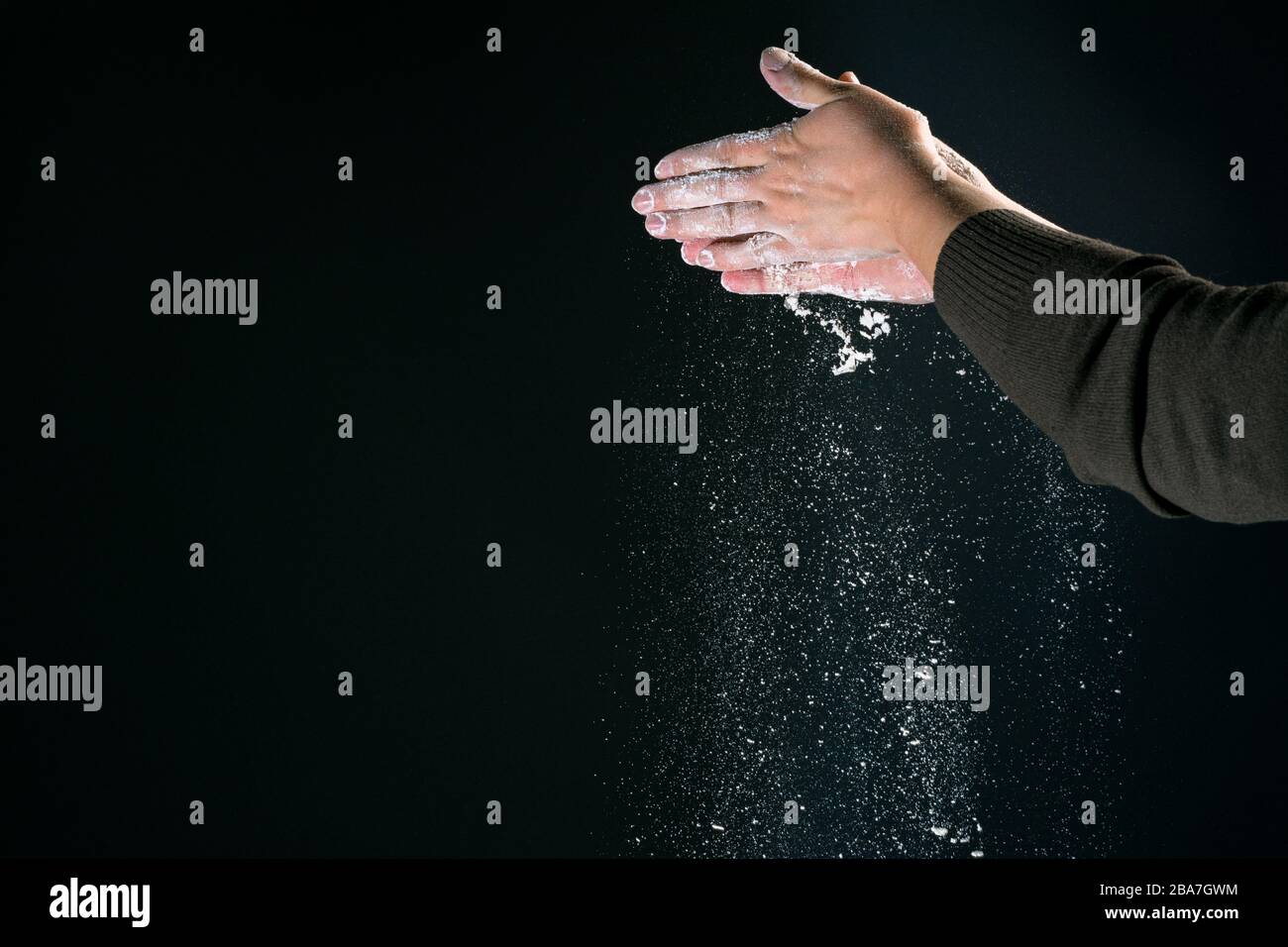 hand of woman cook in kitchen pouring white dust flour flour table for ...