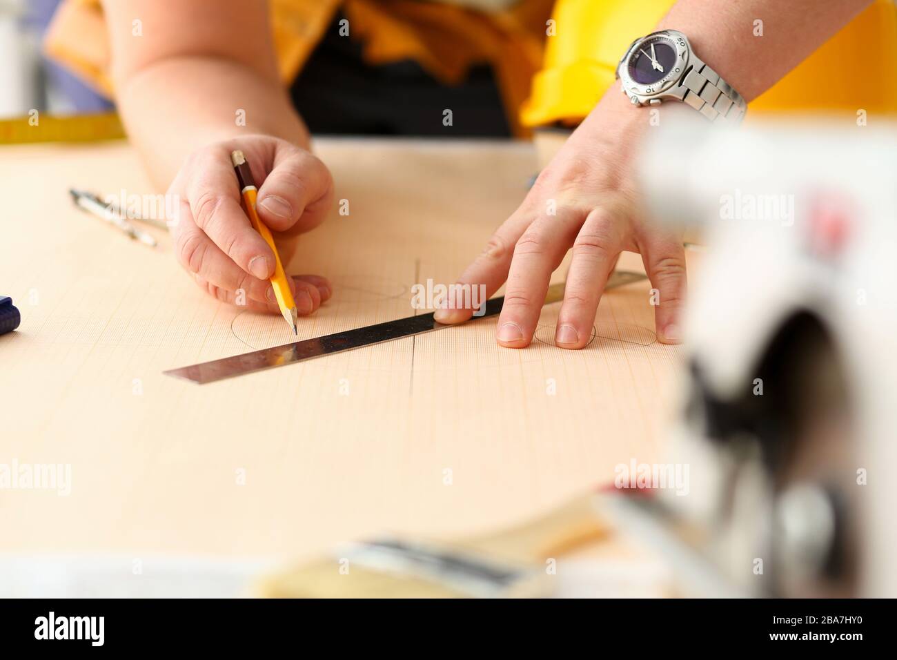 Arms of worker making structure plan Stock Photo - Alamy