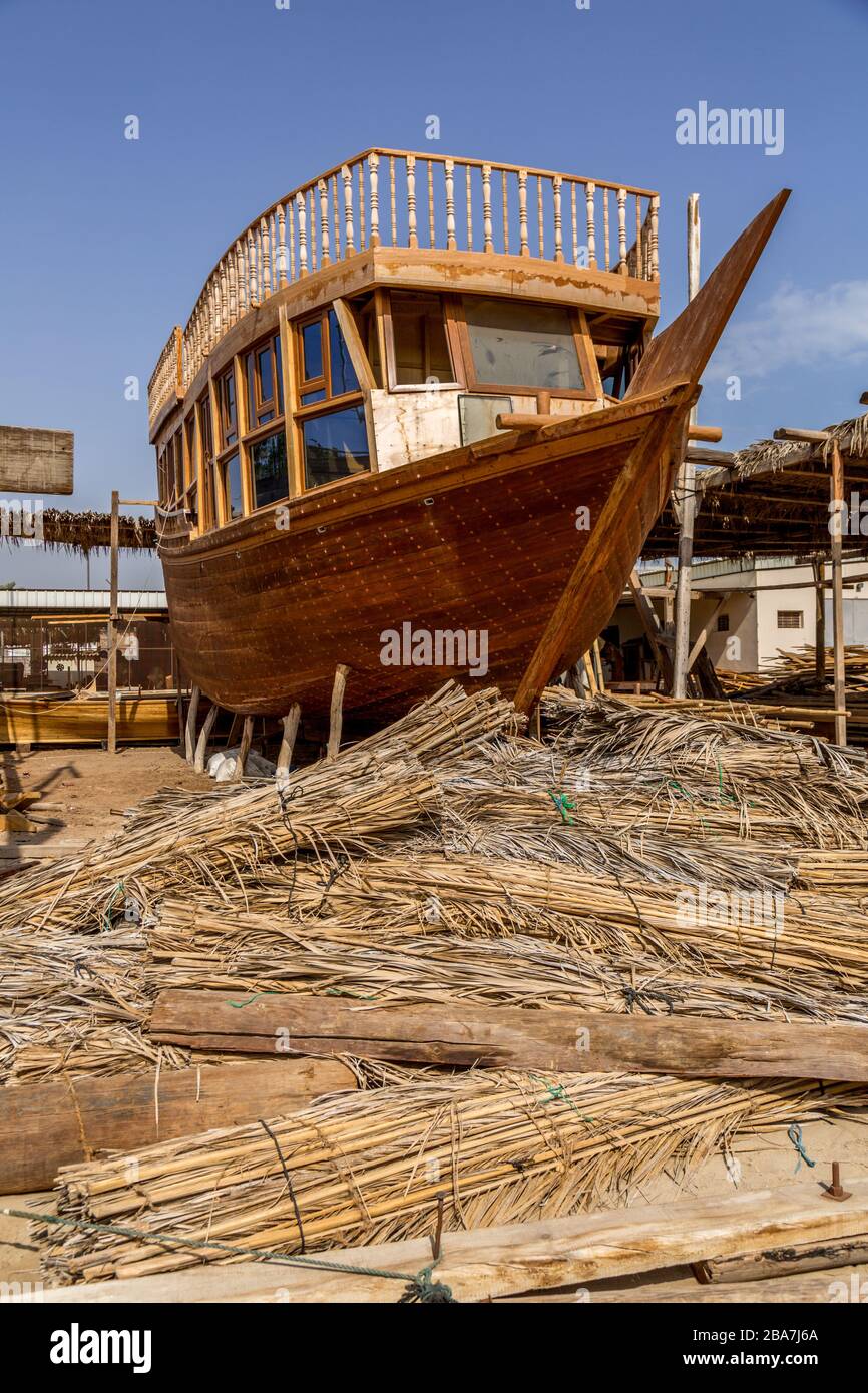 A traditional Dhow boat building yard in the city of Sur, Oman. The ...
