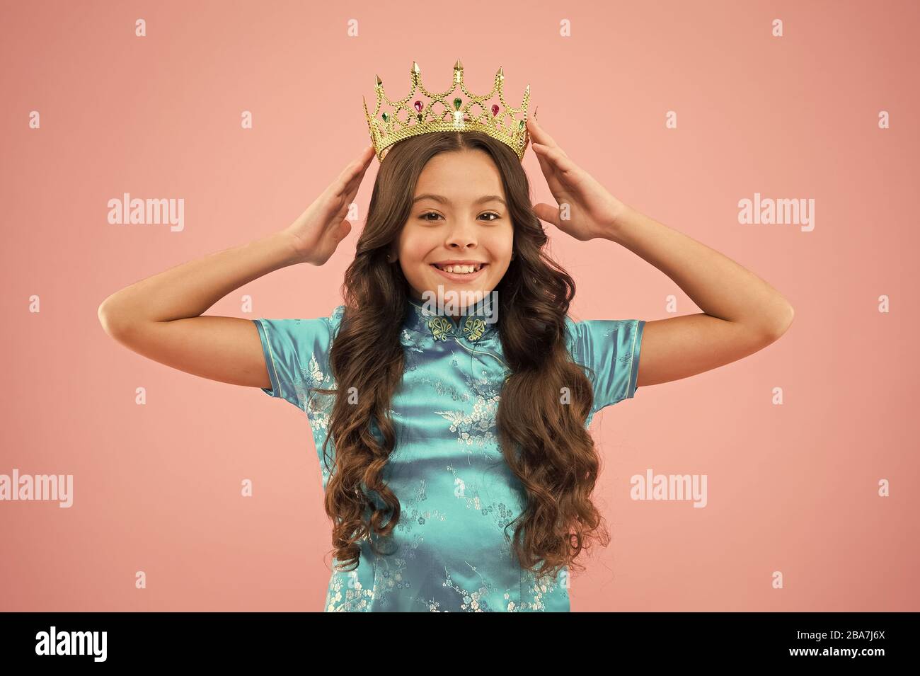 pageant queen. happy kid chinese dress wear crown. portrait of pride ...