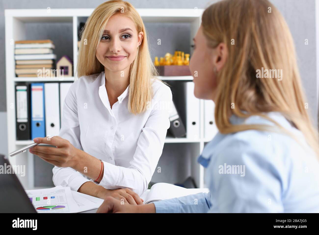 Group of people deliberate on white board problem Stock Photo - Alamy