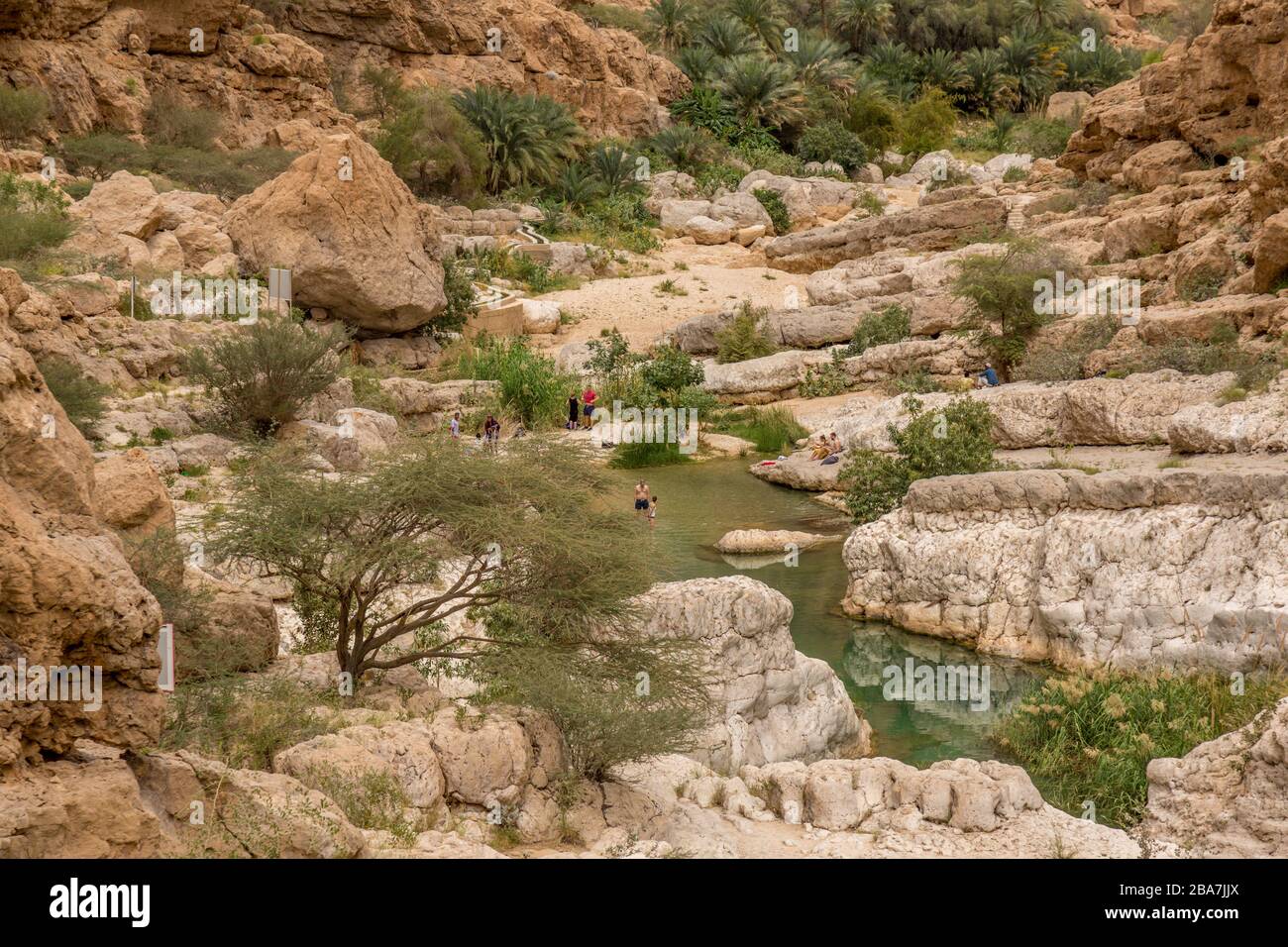 Wadi Shab, Oman. Tourists enjoying hiking, swimming, and sunbathing ...