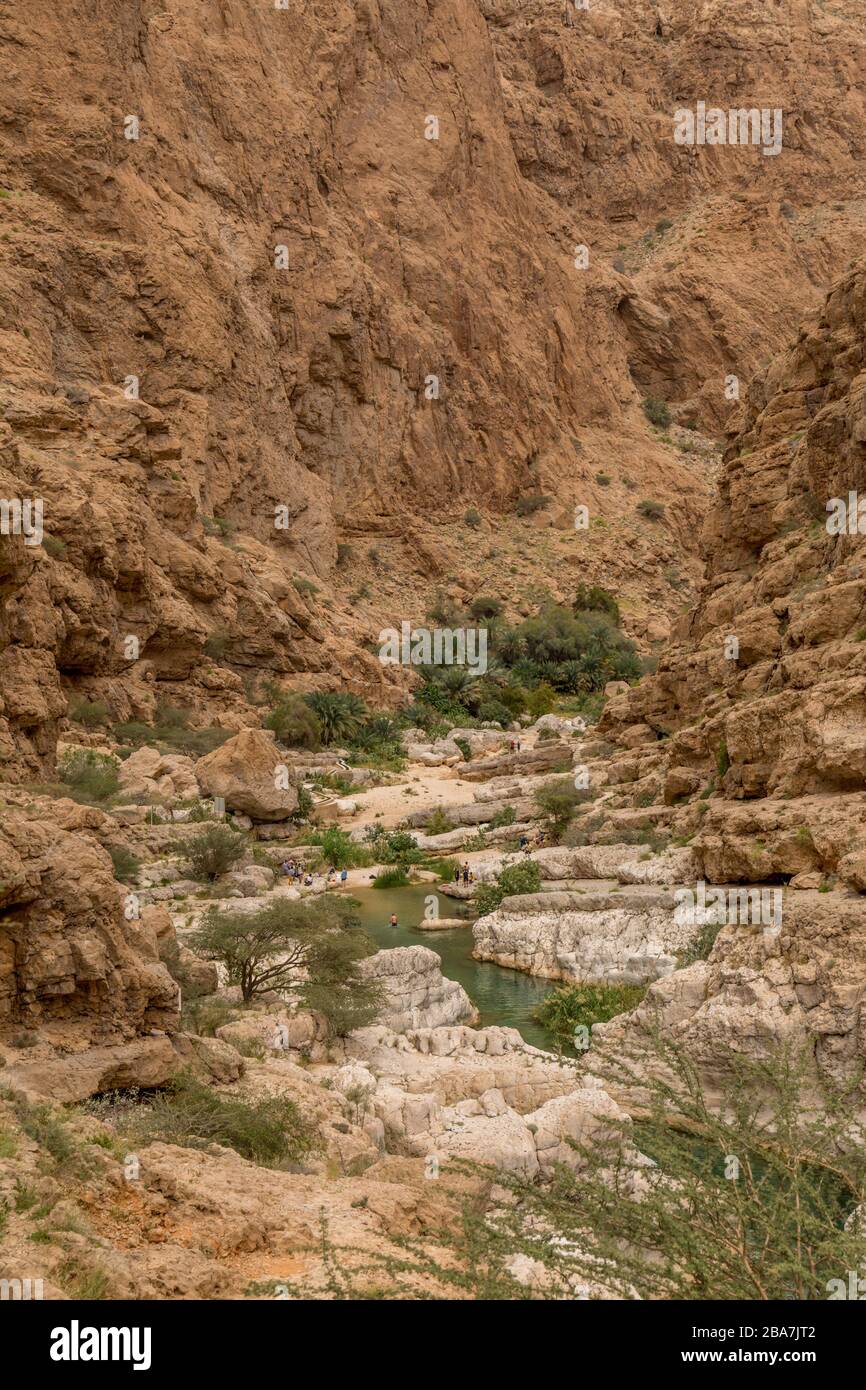 Wadi Shab, Oman. Tourists enjoying hiking, swimming, and sunbathing ...
