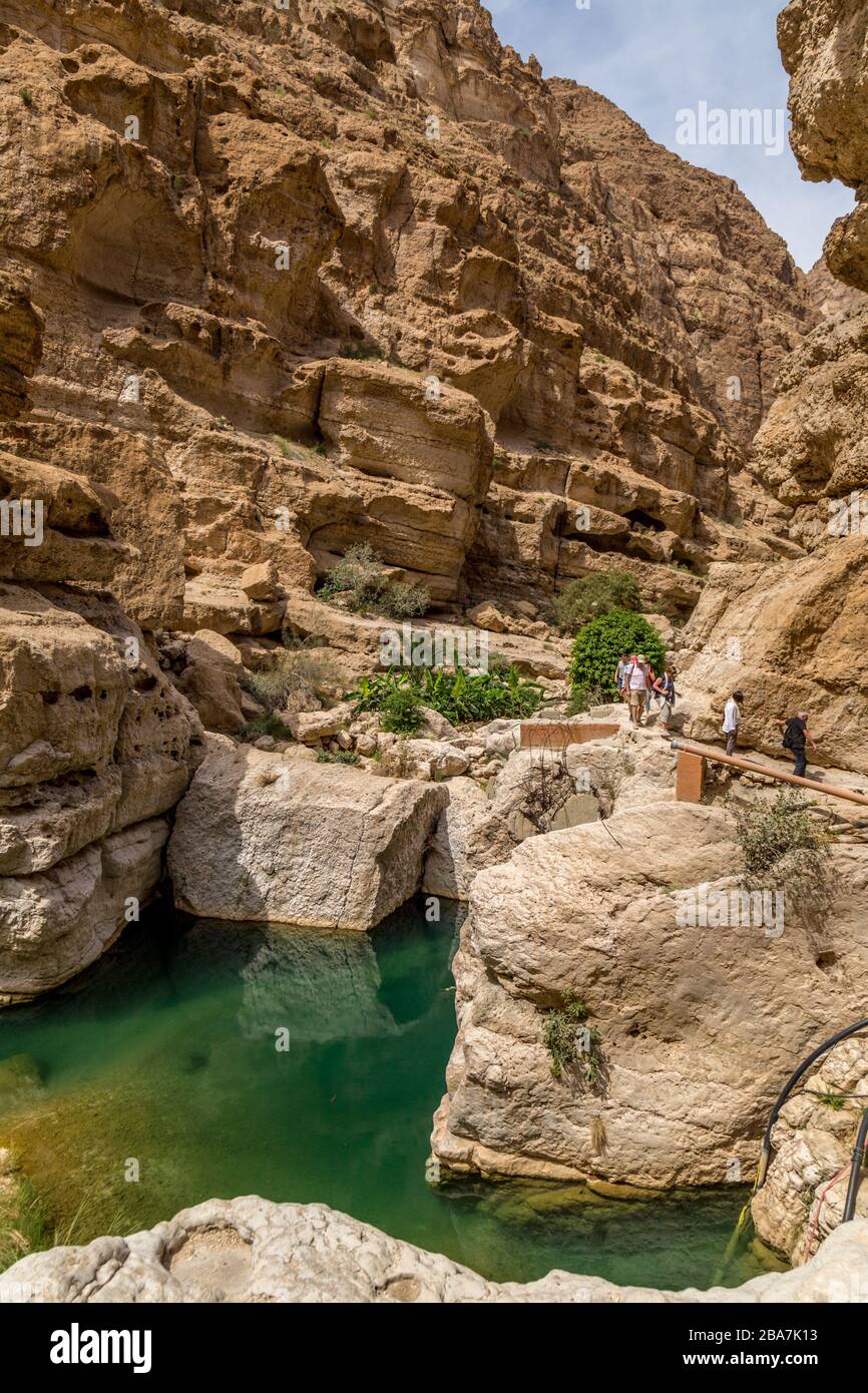 Wadi Shab, Oman. Tourists enjoying hiking, swimming, and sunbathing ...