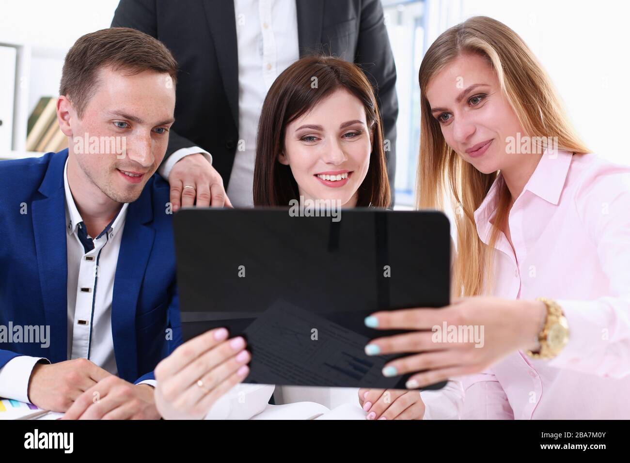 Group of people in office look at mobile tablet pc Stock Photo - Alamy