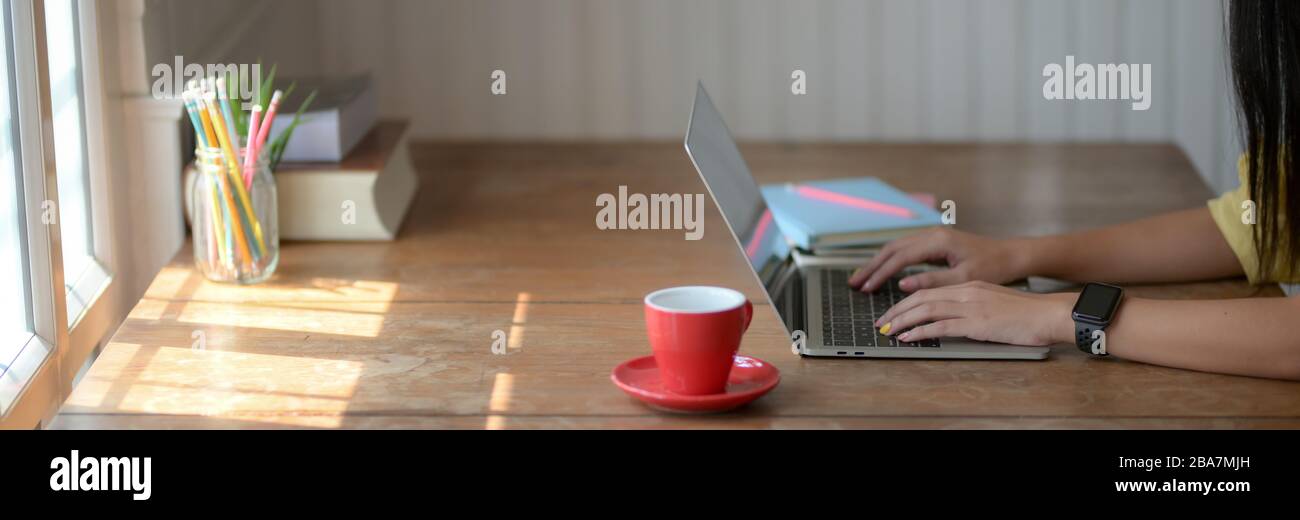 Side view of young female college student doing homework with blank ...