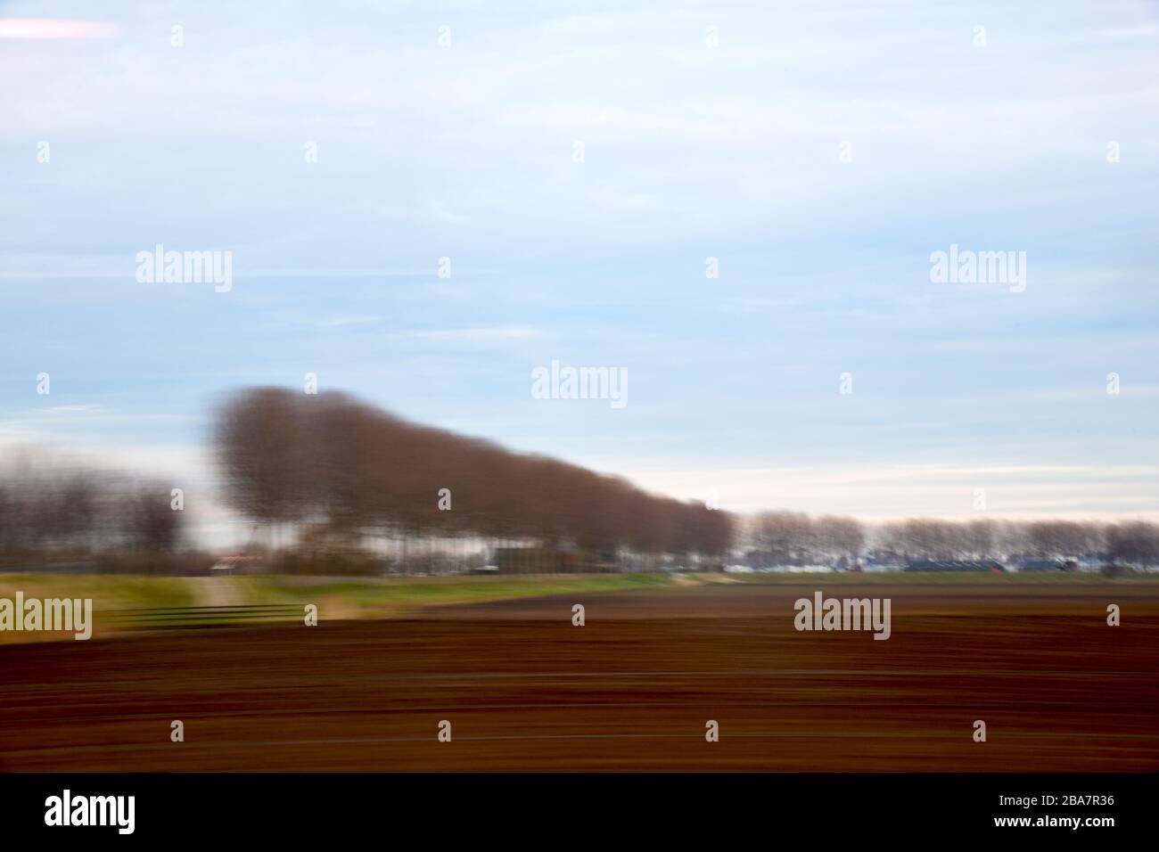 Blurry agricultural landscape; taken from high speed train with nicely ...