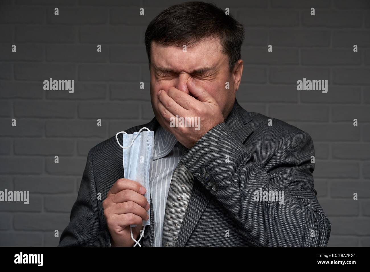 infected man sneezes or coughs and has symptoms of the disease ...