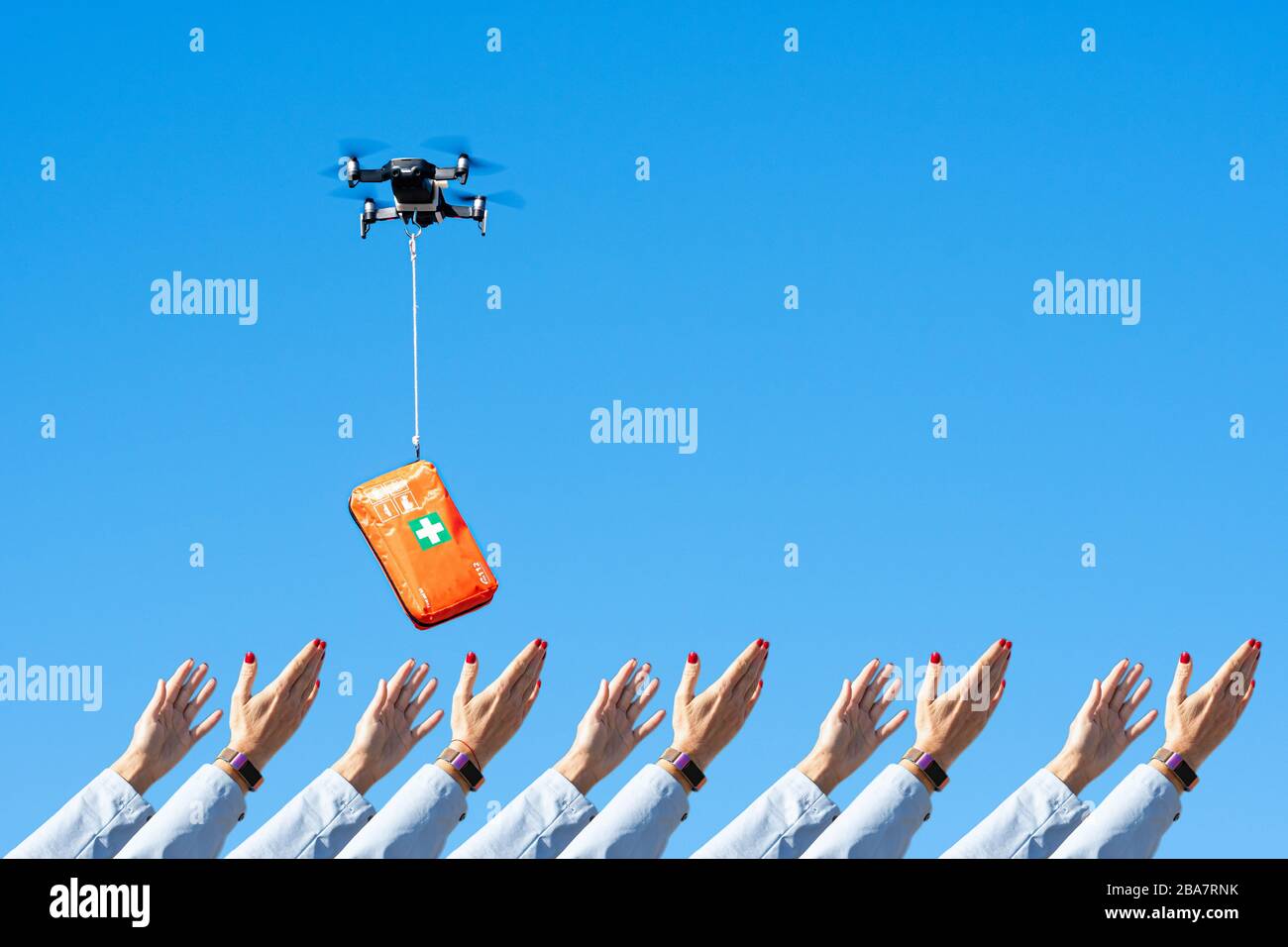 many human hands receiving the first aid kit with coronavirus ...