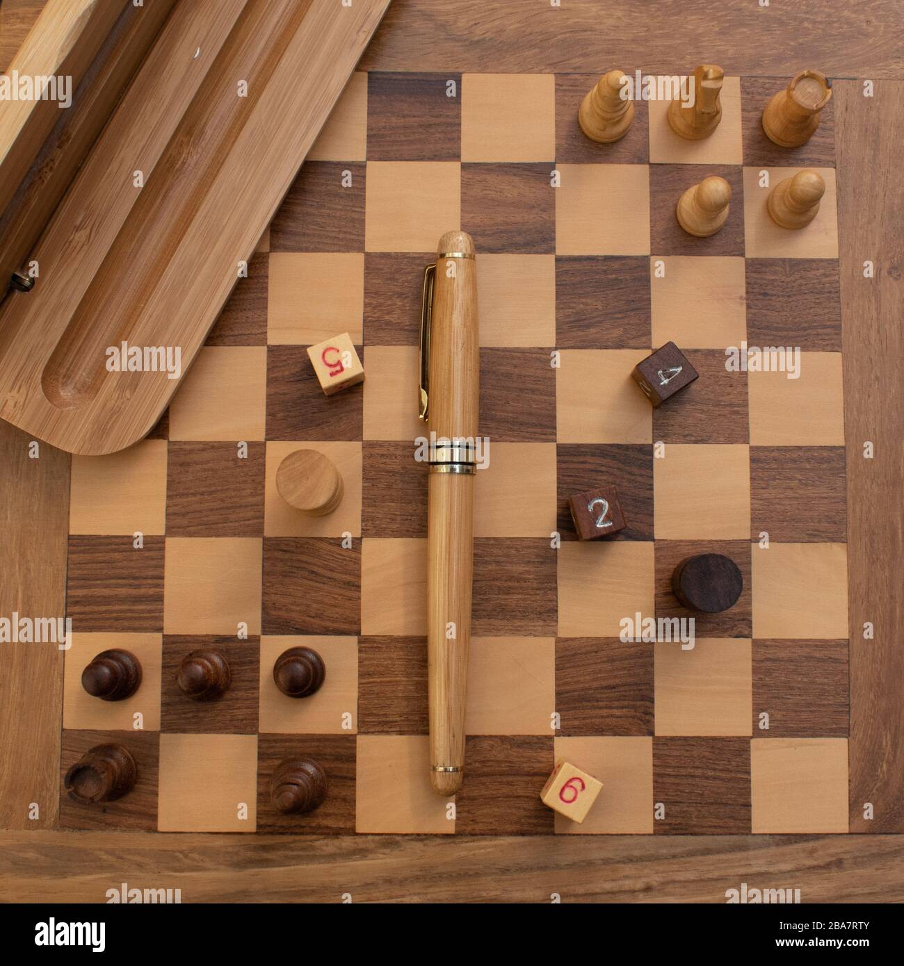 A stylistic photo of a wooden fountain pen laid on a chess set Stock ...