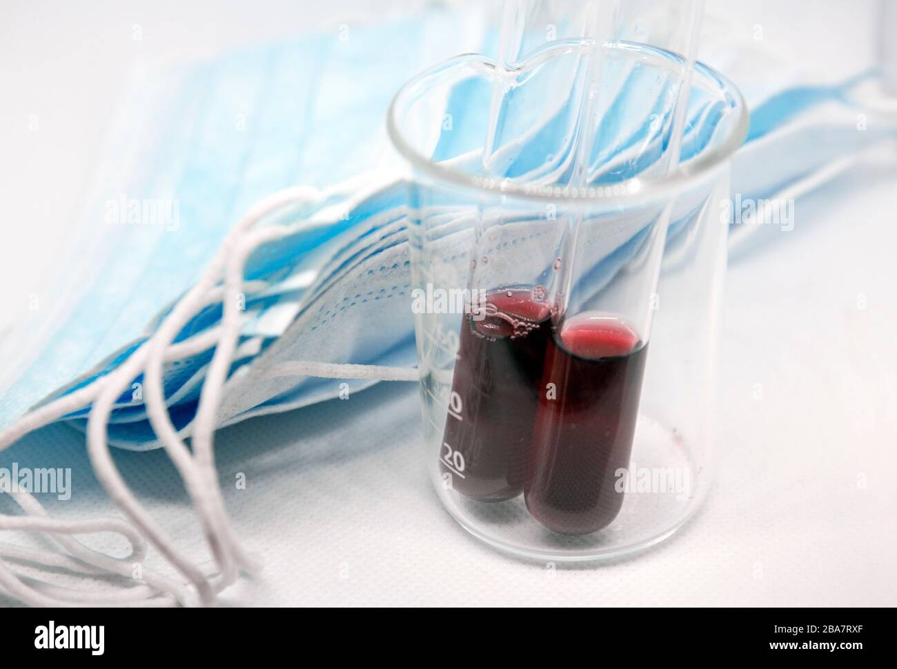 Surgical protection mask with blood test tube Stock Photo - Alamy