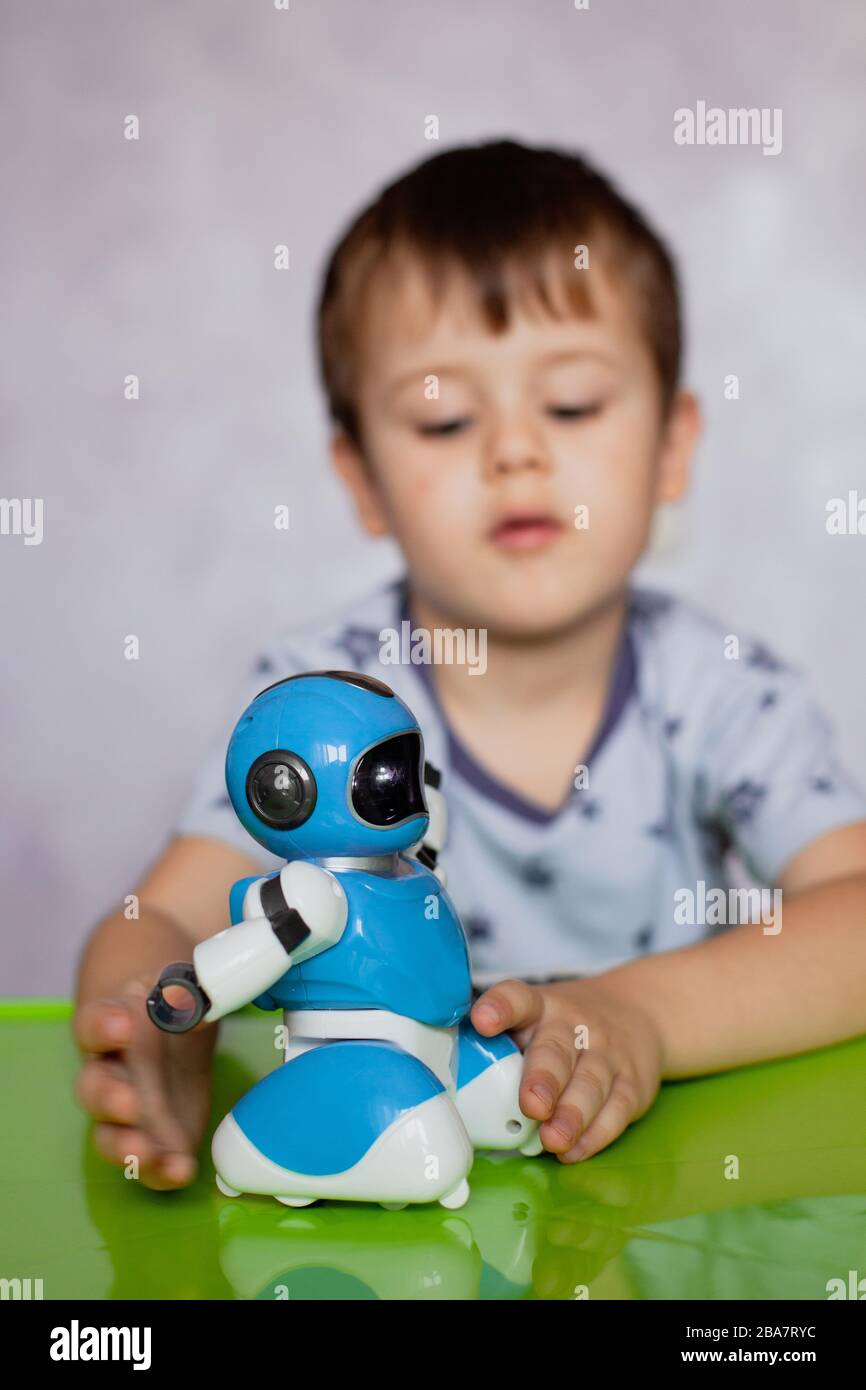 Little boy is playing with robot. Robot for children. Smart toy Stock ...