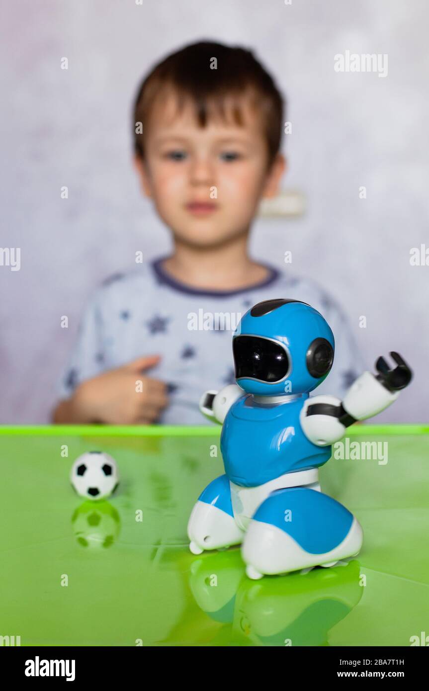 Little boy is playing with robot. Robot for children. Smart toy ...