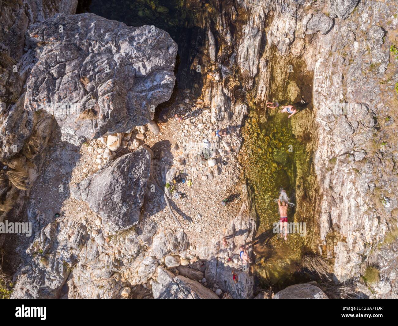 A tourist jumps into a large pool in a river in Zimbabwe's Chimanimani ...