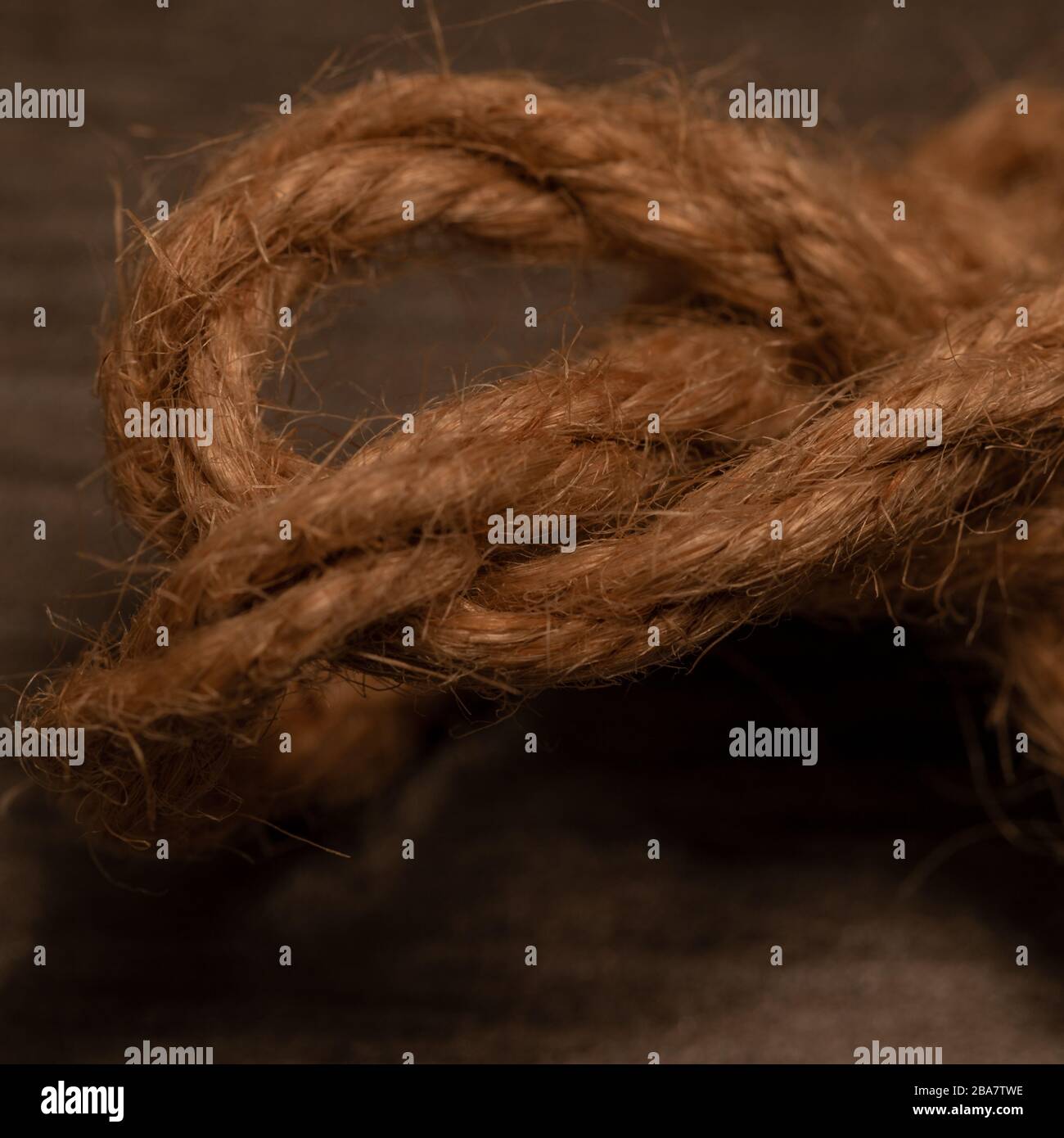 close up of a light brown rope string on brownback ground Stock Photo ...