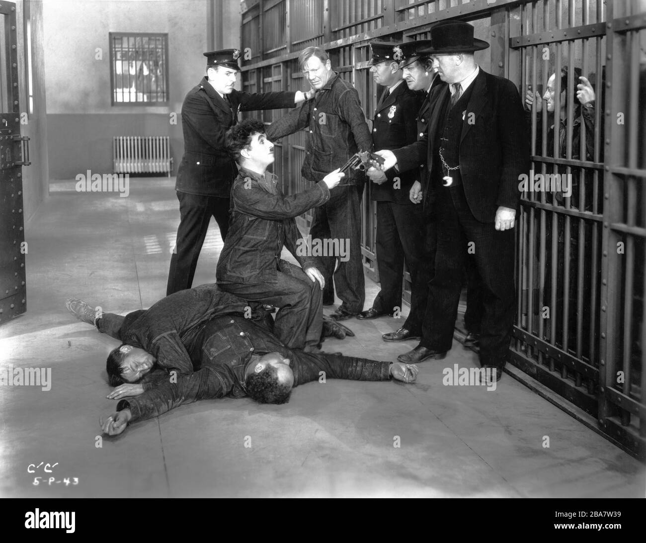 CHARLIE CHAPLIN as the Tramp and FRANK MORAN as Convict (standing) in ...