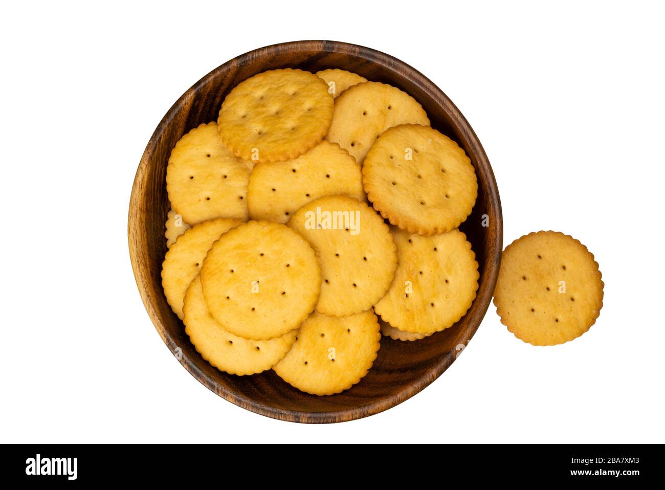 Top view of crunchy round crackers in wooden bowl on white background ...