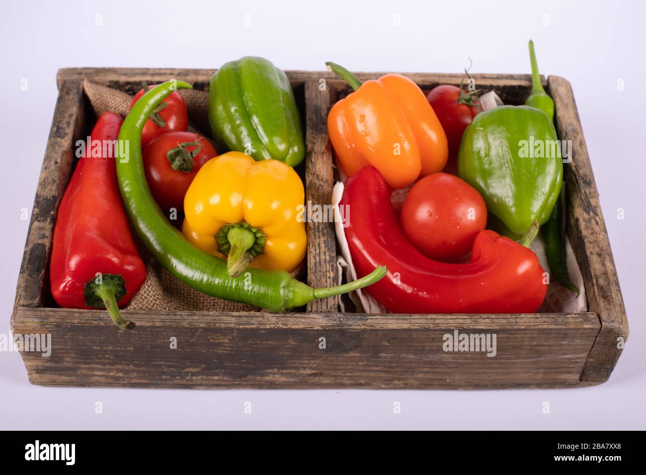 Color pepper wooden tray in white background Stock Photo - Alamy