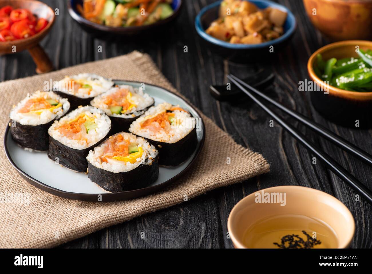 selective focus of tasty gimbap with vegetables and salmon near ...