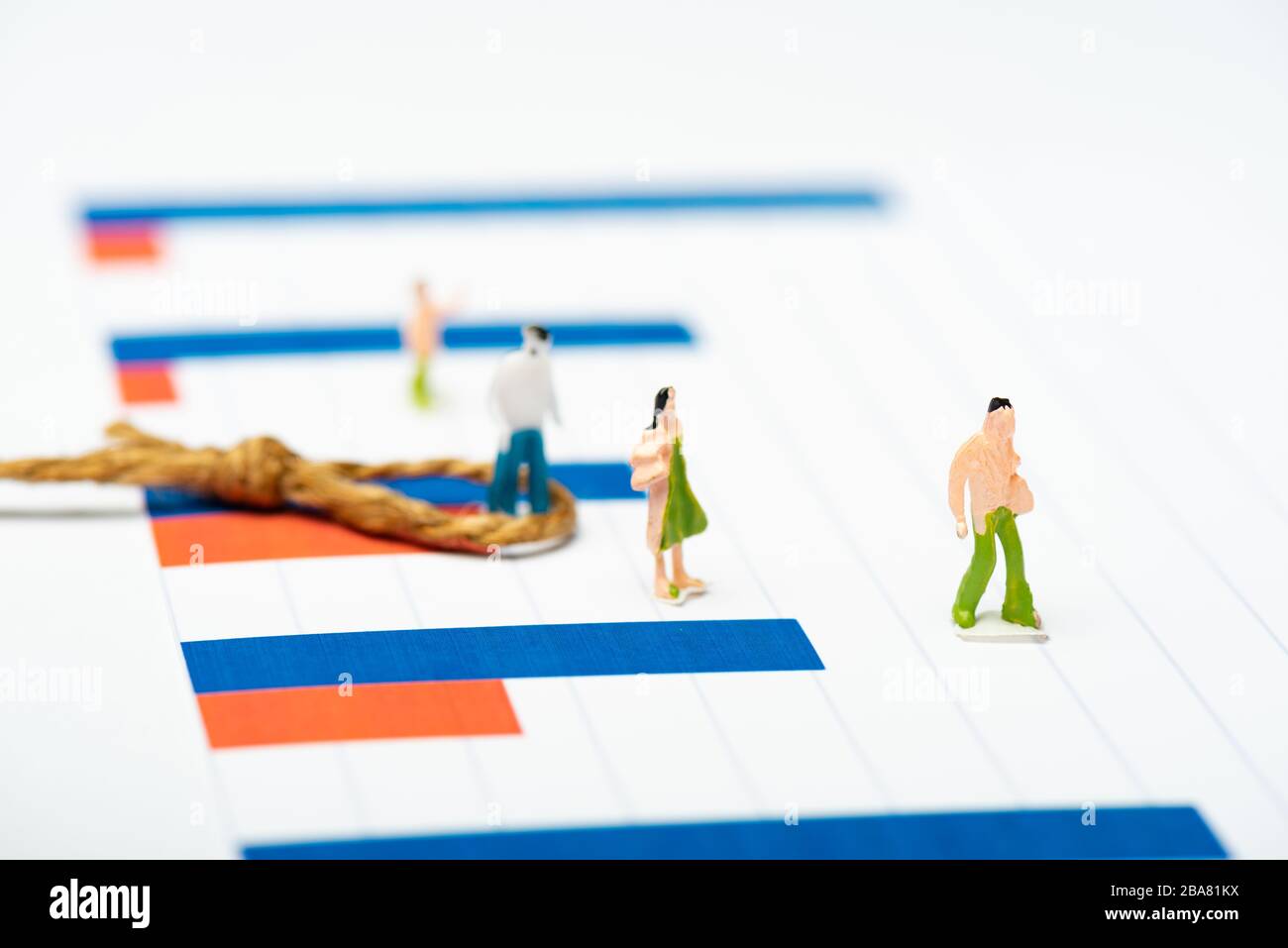 Selective focus of people figures with noose on graphs on white surface ...