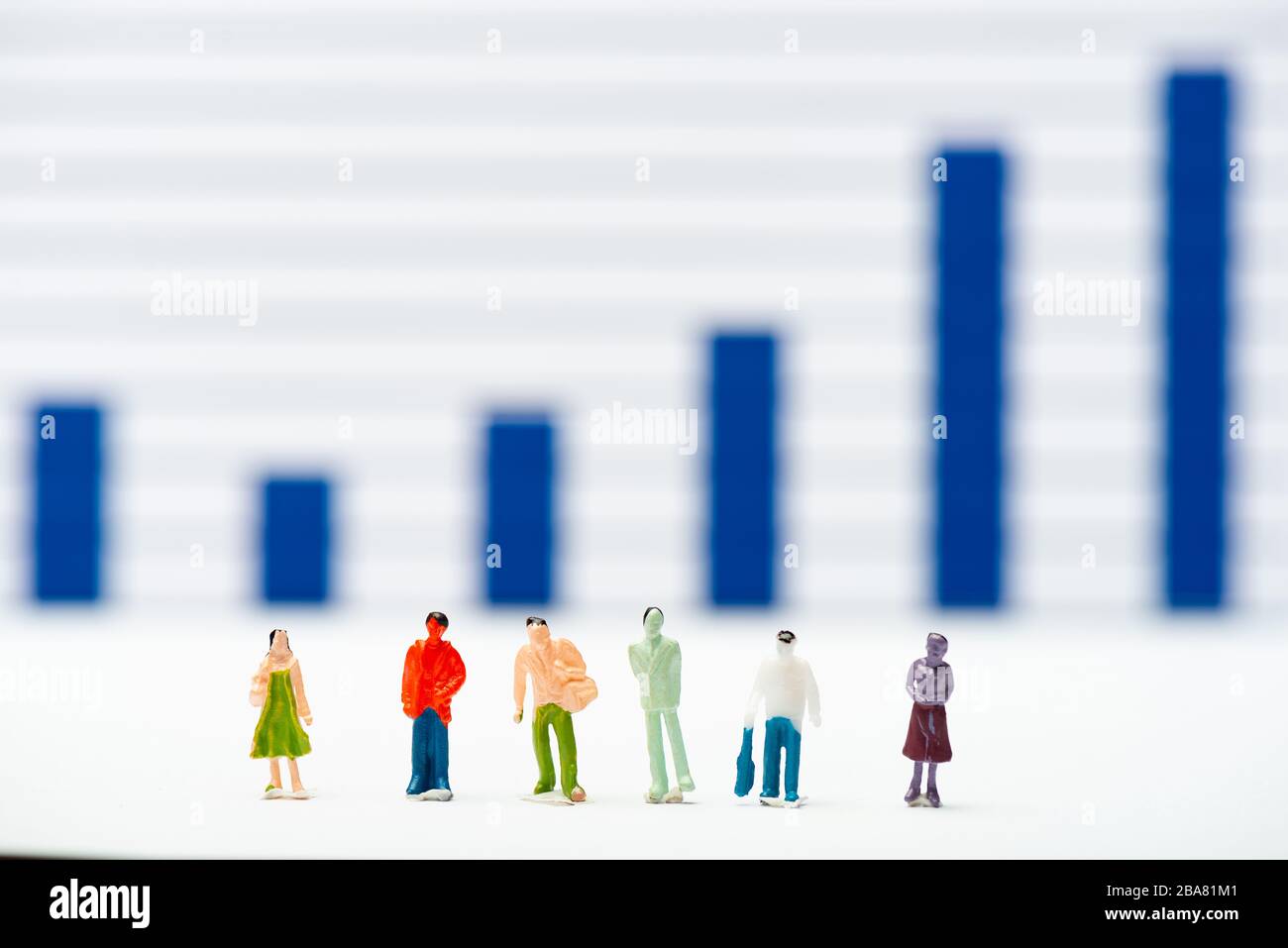 Selective focus of people figures on white surface with infographics at ...