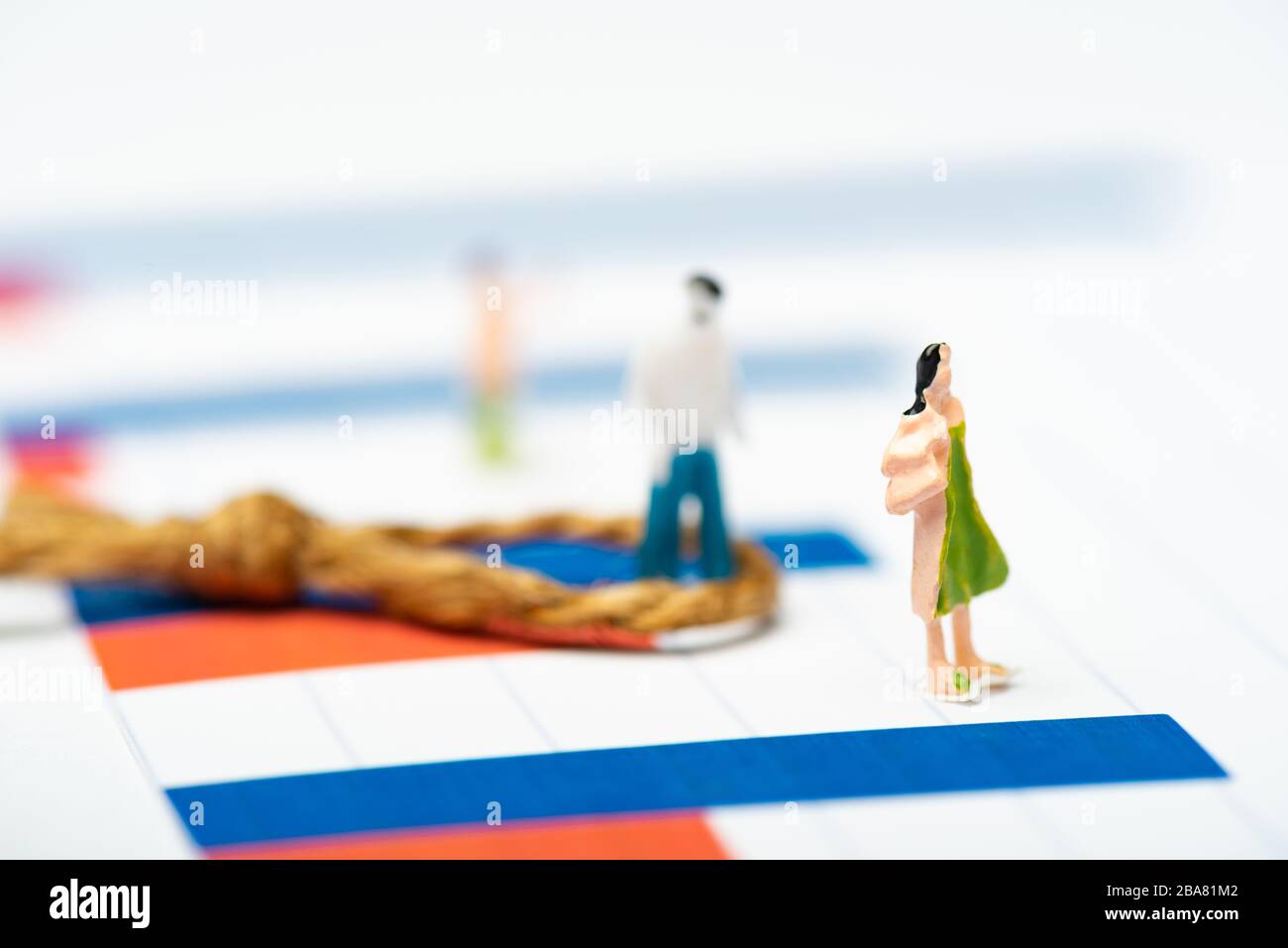 Selective focus of plastic people figures with noose on charts on white ...