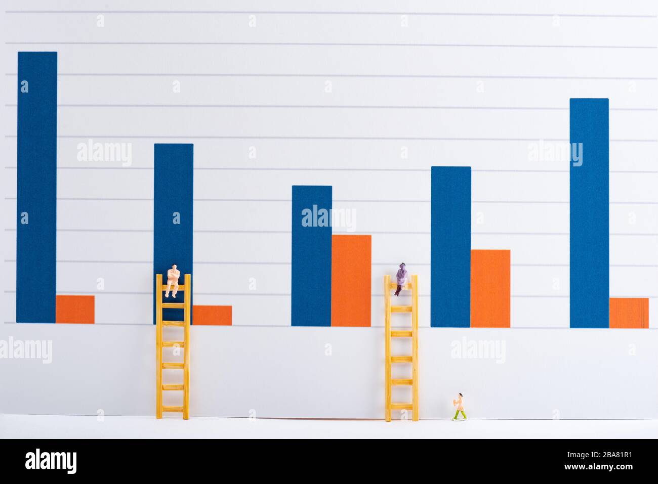 People figures with ladders on white surface with charts at background ...