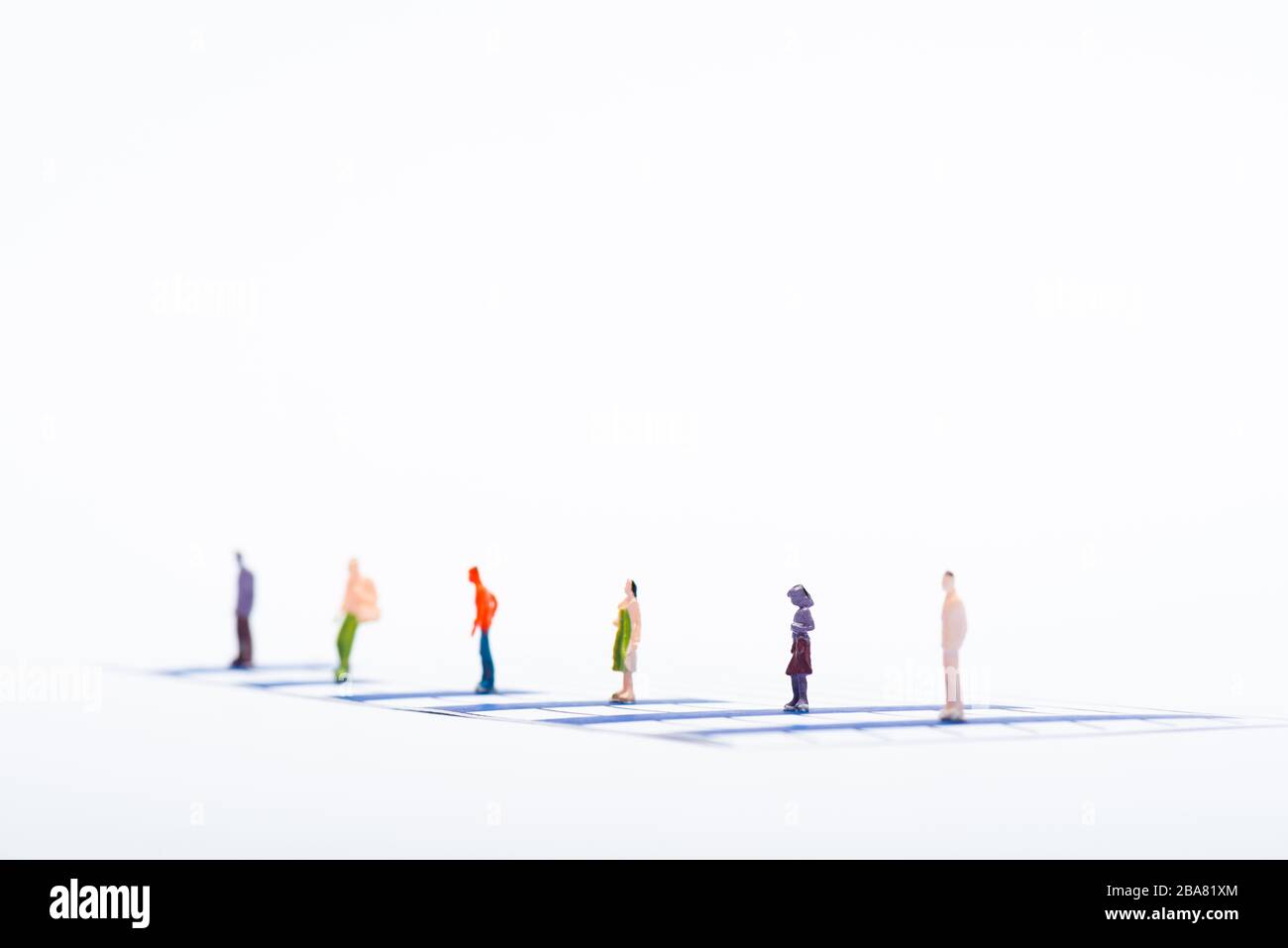 Selective focus of people figures on blue charts isolated on white ...