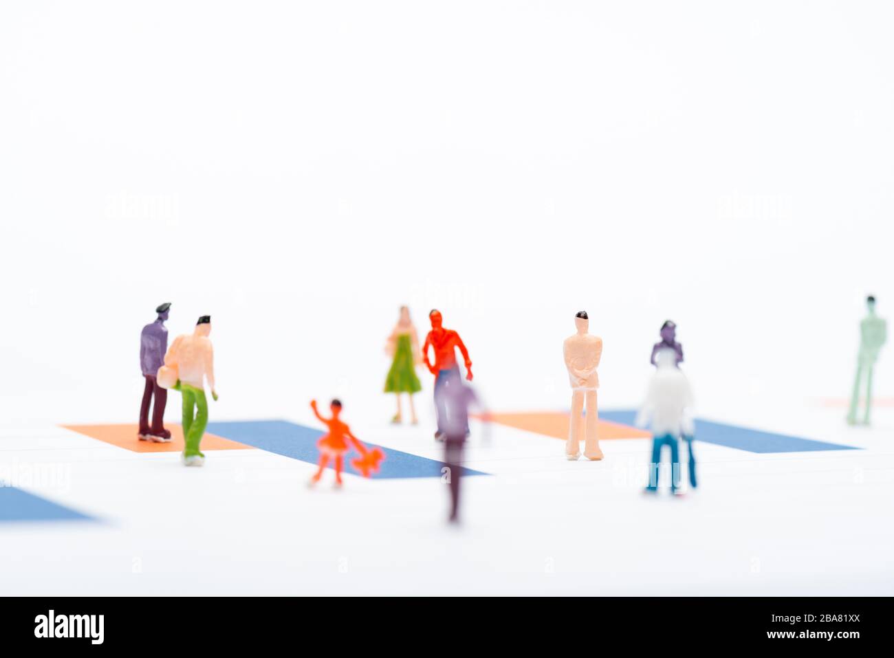 Selective focus of plastic people figures on surface with charts ...