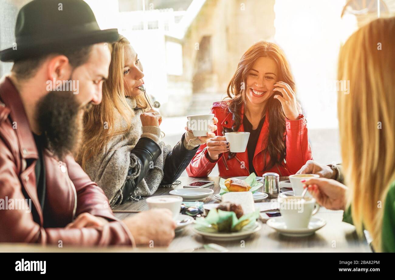 Young friends toasting coffee and doing breakfast in bar bakery shop ...